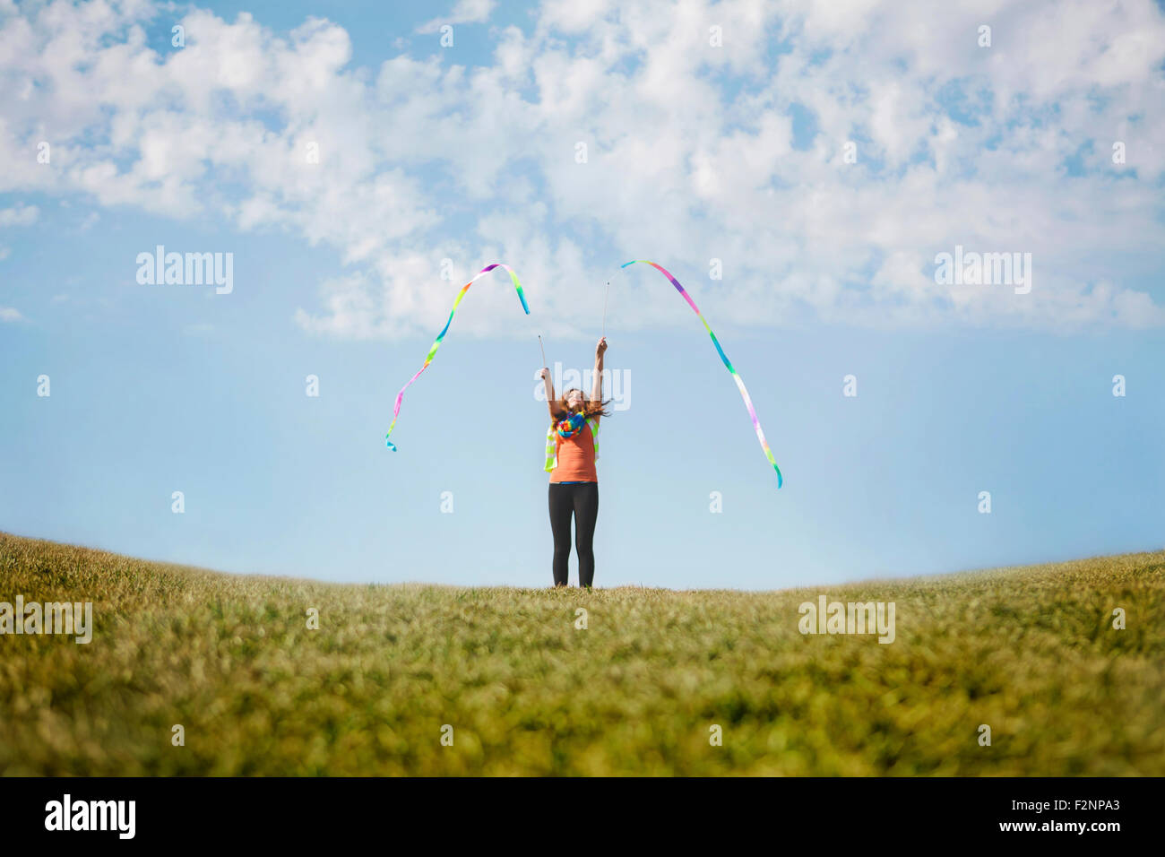 Caucasian girl playing with ribbons on hilltop Stock Photo - Alamy