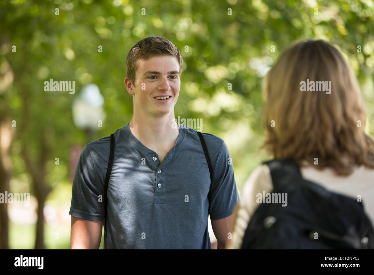 Caucasian students talking on sidewalk Stock Photo - Alamy