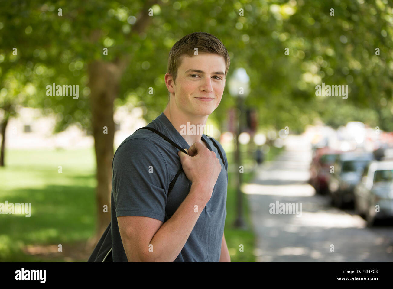 Caucasian student smiling on sidewalk Stock Photo - Alamy
