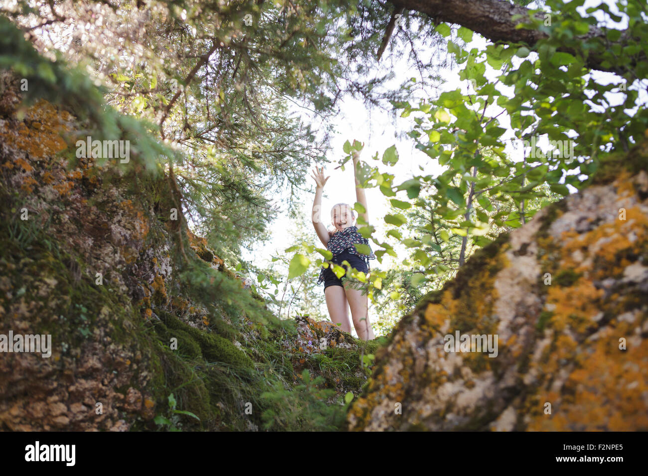 Caucasian girl playing in forest Stock Photo - Alamy