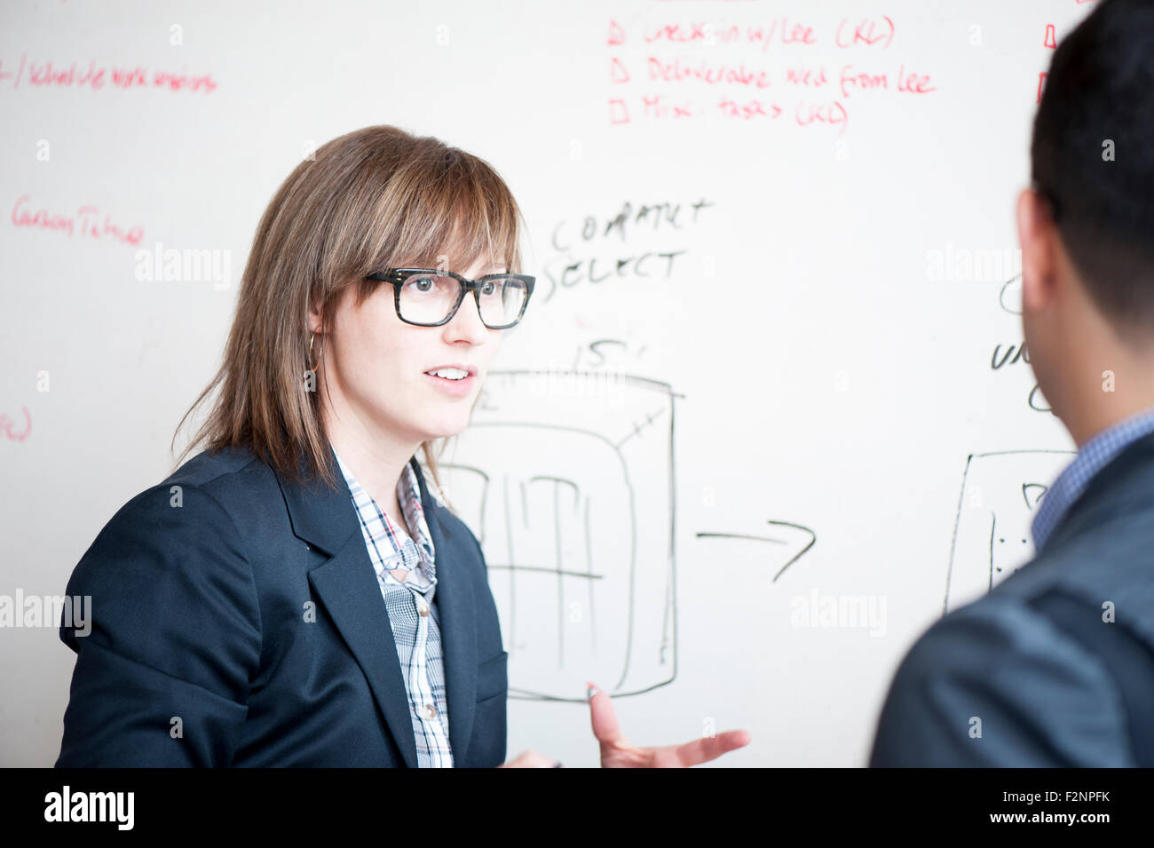 Business people writing on whiteboard in office Stock Photo - Alamy