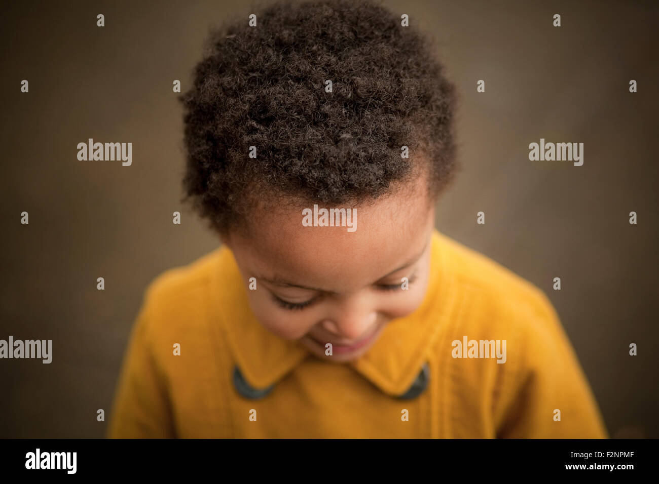 Close up of girl wearing yellow coat Stock Photo - Alamy