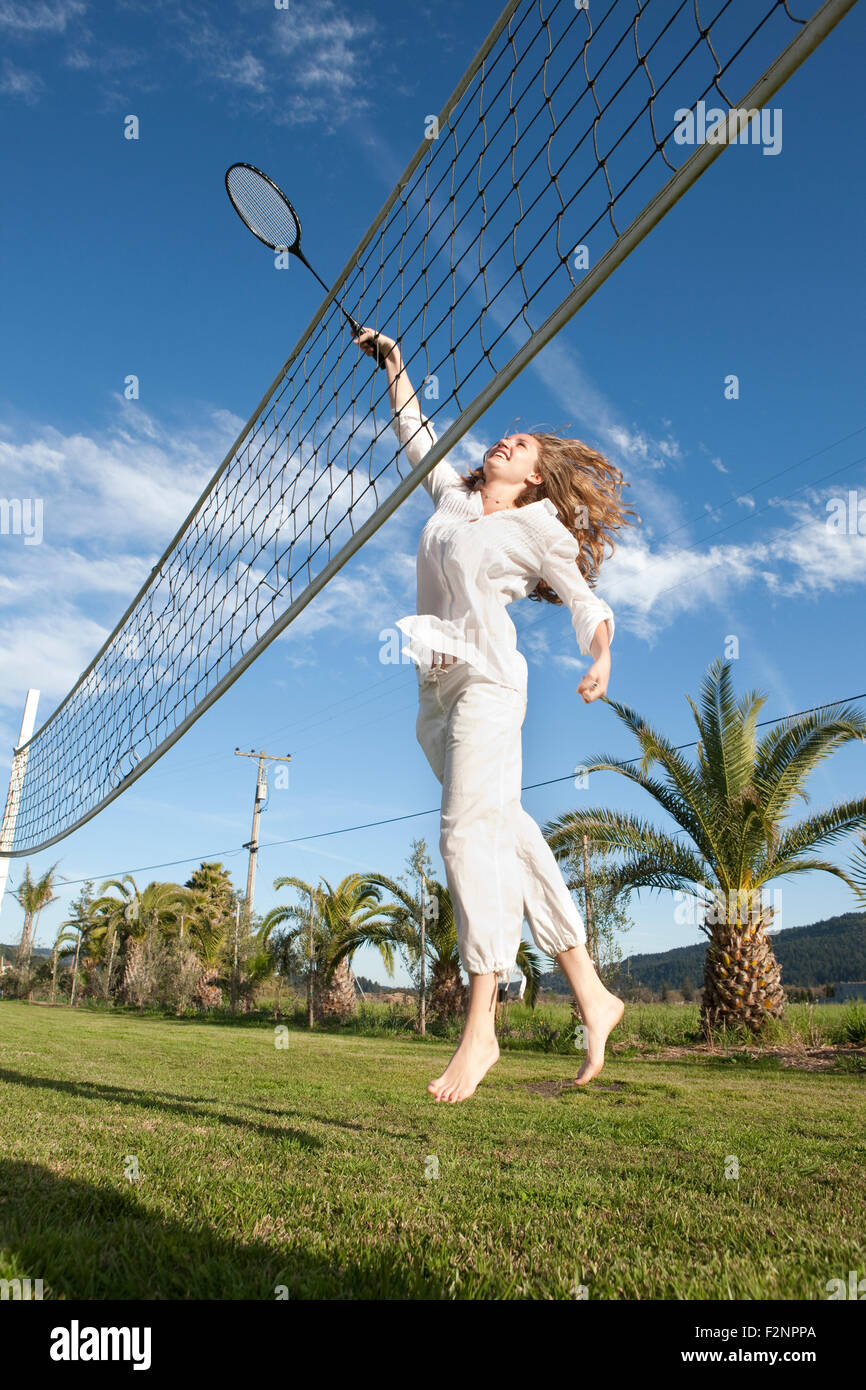 Woman playing badminton in park Stock Photo - Alamy