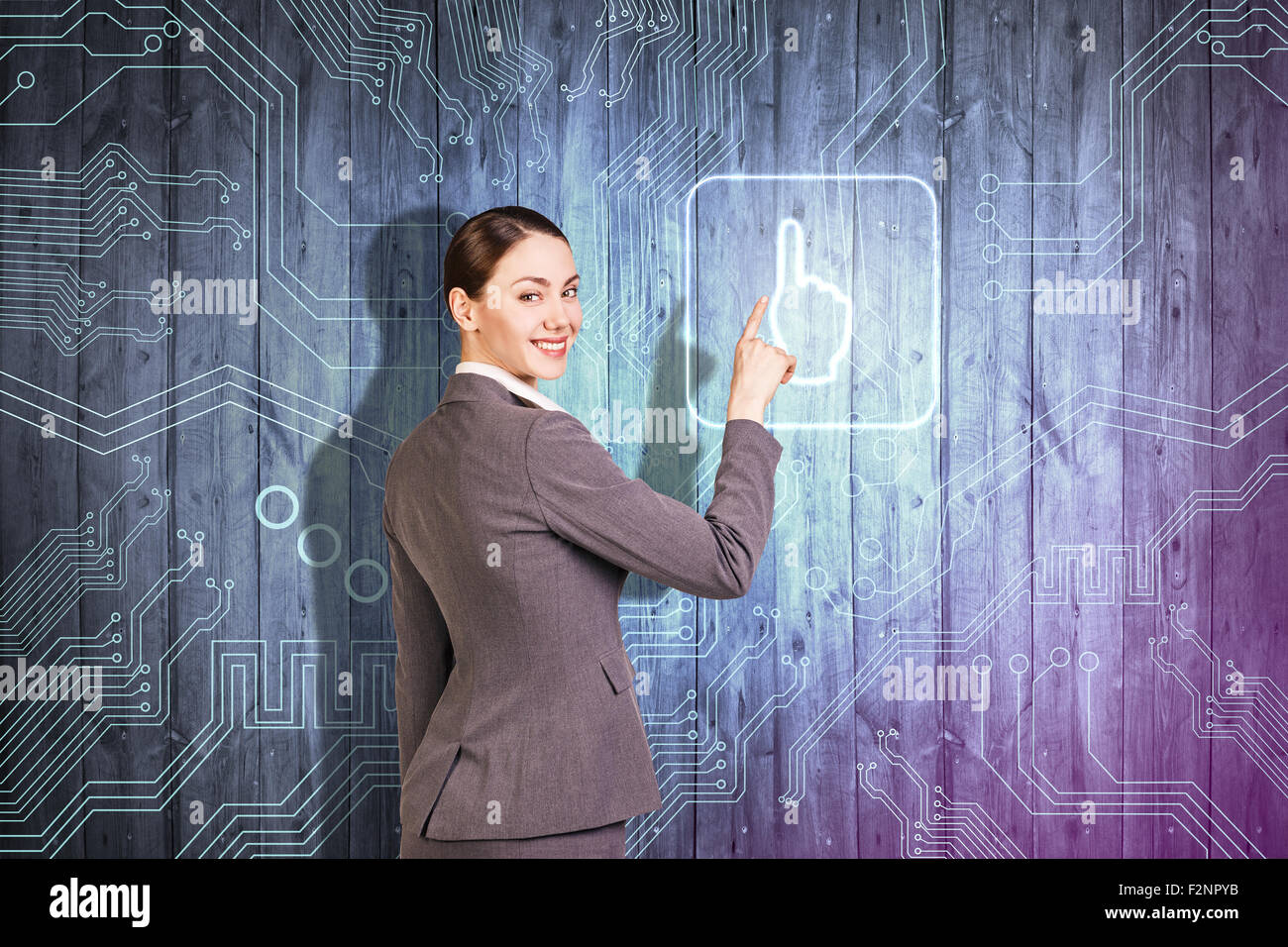 Smiling business woman point to the icon Stock Photo - Alamy