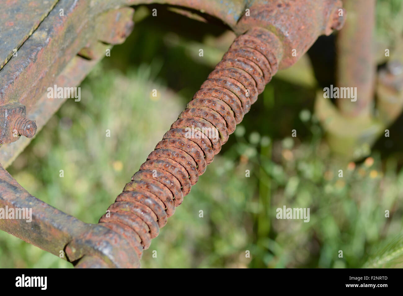 Rusty old farm machinery in garden of property in French countryside ...