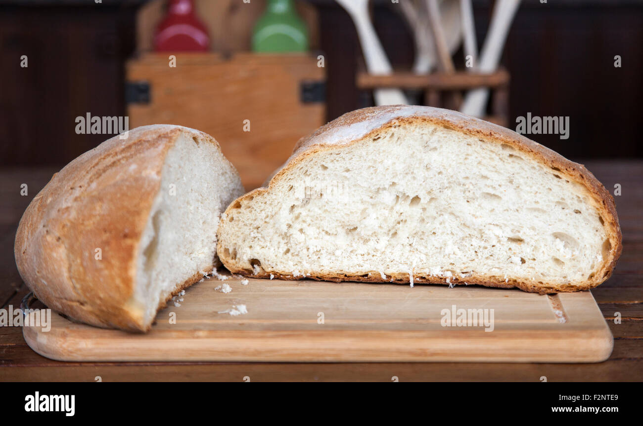 Close up view of an open large loaf of bread in a rustic kitchen Stock ...