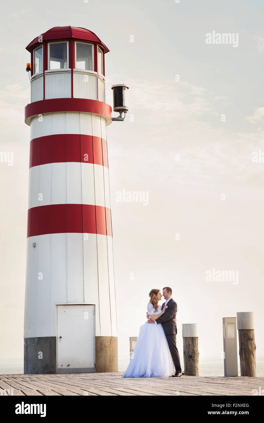 Beautiful young wedding couple in front of lighthouse Stock Photo - Alamy
