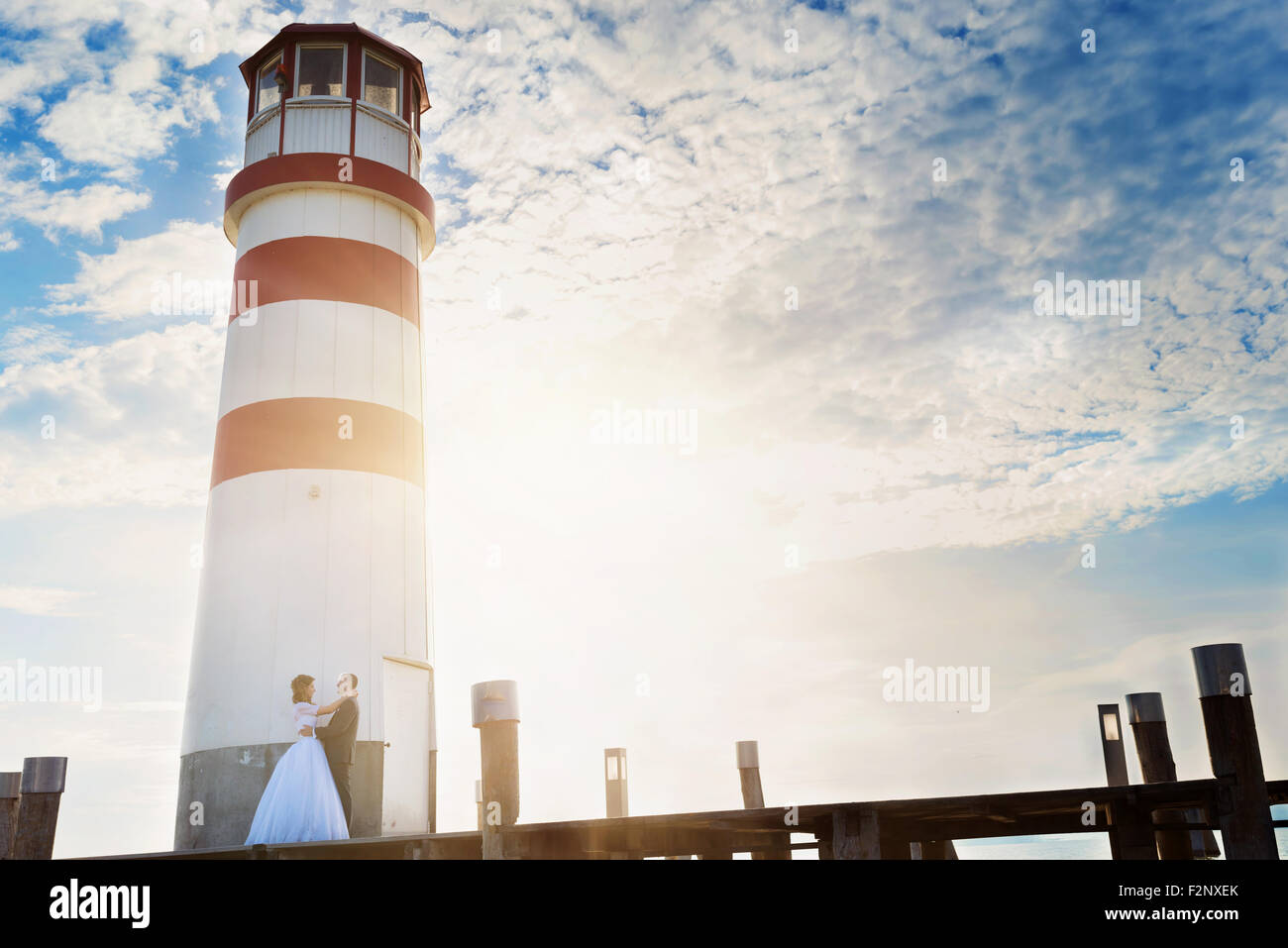 Beautiful young wedding couple in front of lighthouse Stock Photo - Alamy