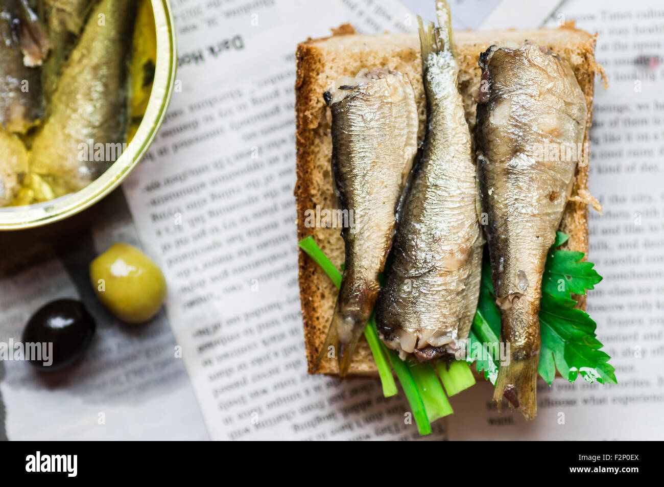 Sandwich with sardine on newspaper top view Stock Photo - Alamy