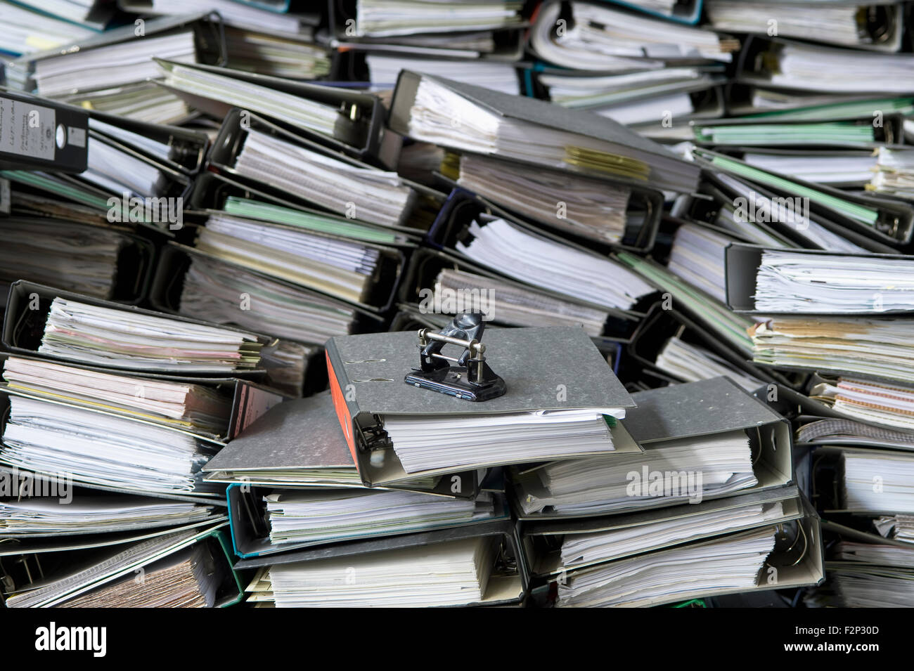 Pile of office files, hole punch Stock Photo - Alamy