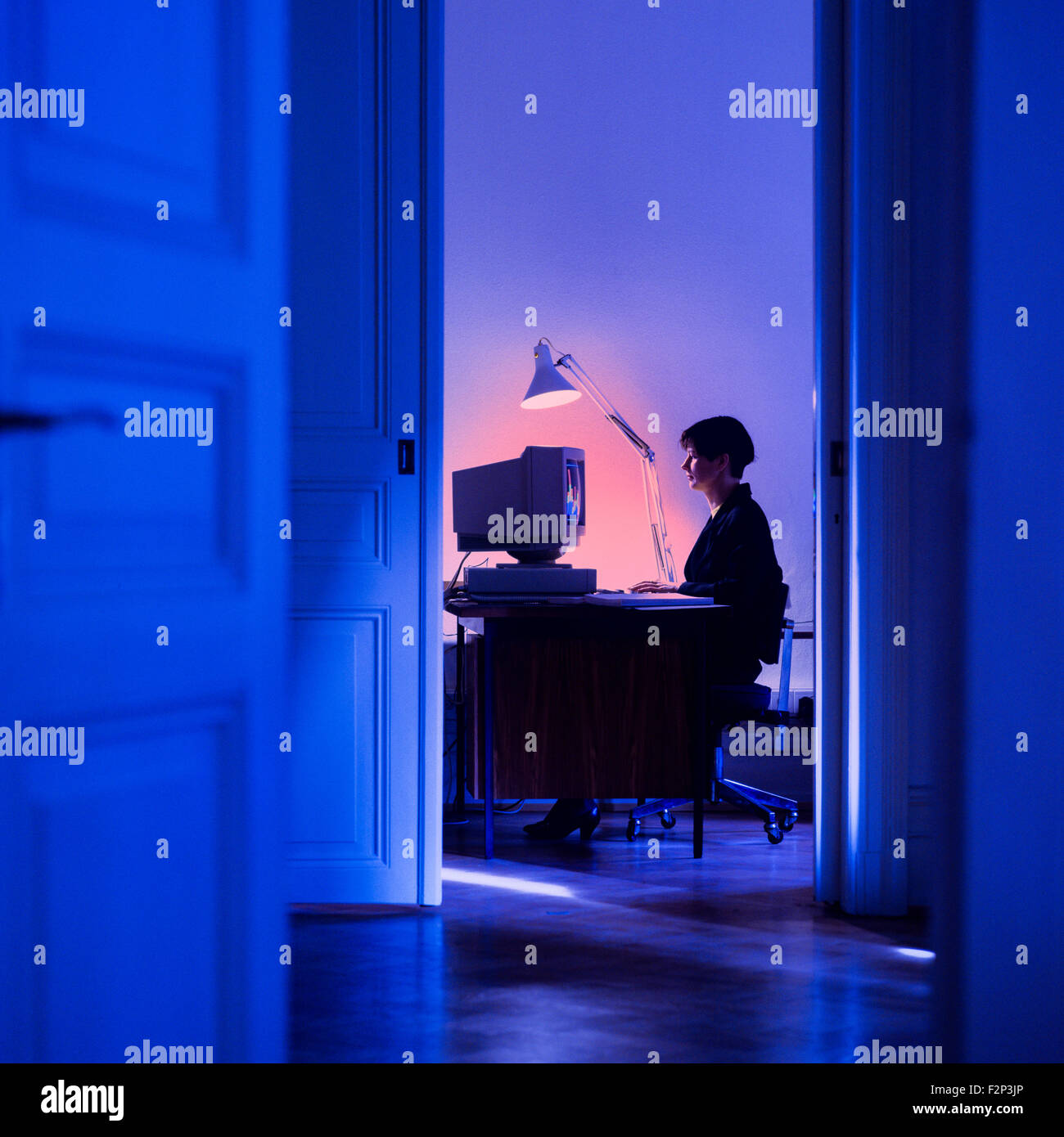 Businesswoman working late at computer in office Stock Photo - Alamy