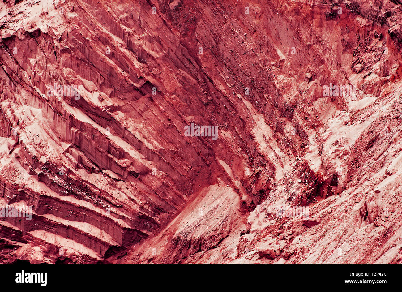 Red fantastic slope with layered texture as abstract background.Toned ...