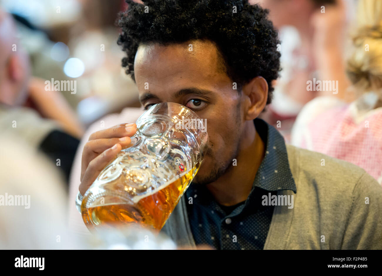 An asylum seeker from Eritrea enjoys the refreshments Sunday at one of ...