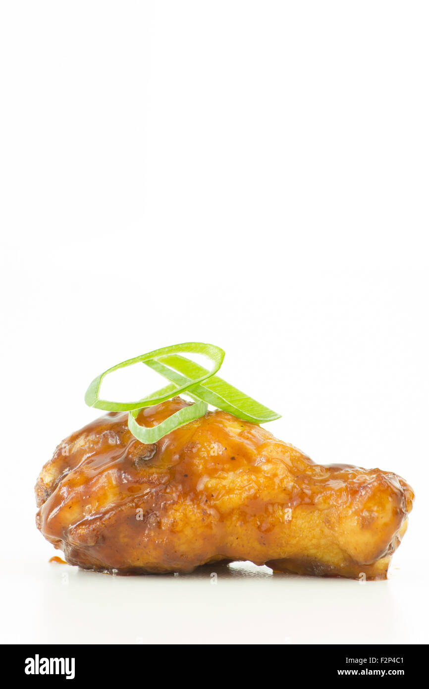Fried chicken wing sprinkled with chives isolated on white Stock Photo ...