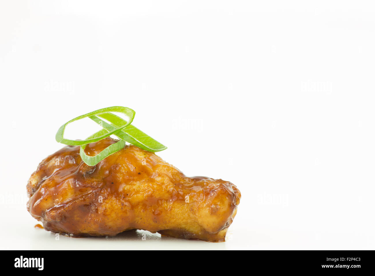 Fried chicken wing sprinkled with chives isolated on white Stock Photo ...