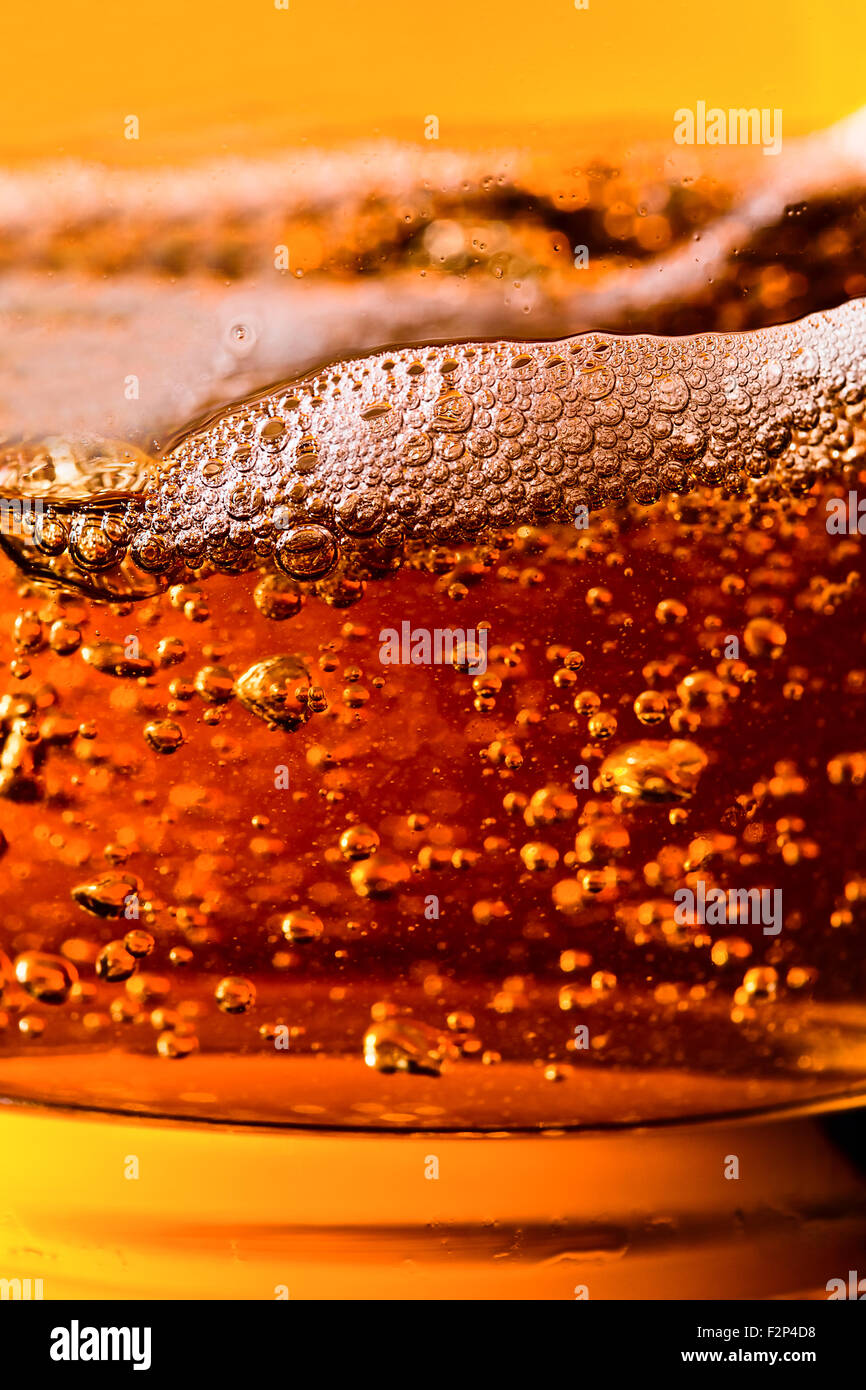 detail of an alcoholic beverage on yellow background Stock Photo - Alamy