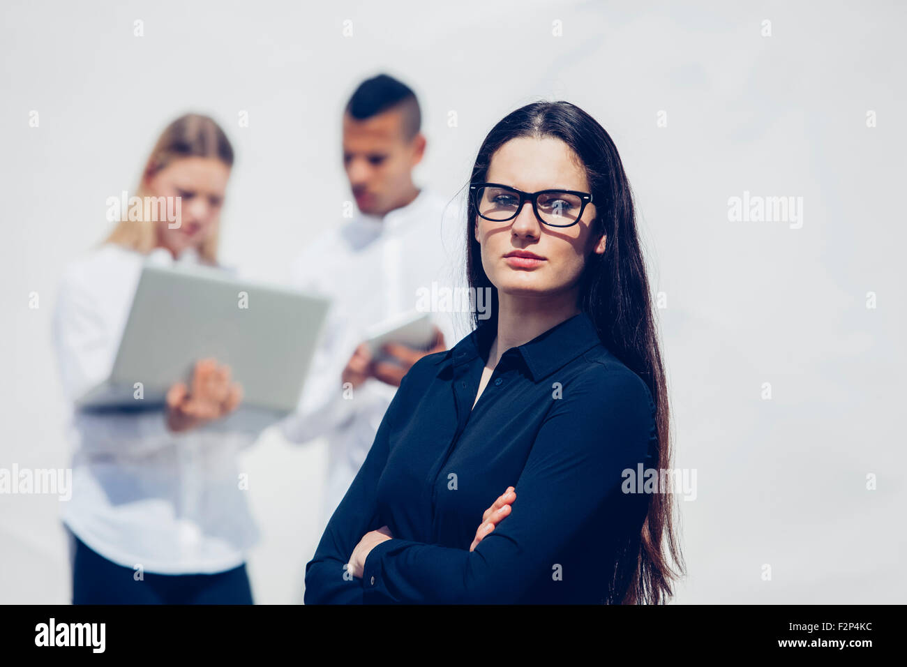 Portrait Of Stylish Young Woman With Crossed Arms Wearing Glasses Stock
