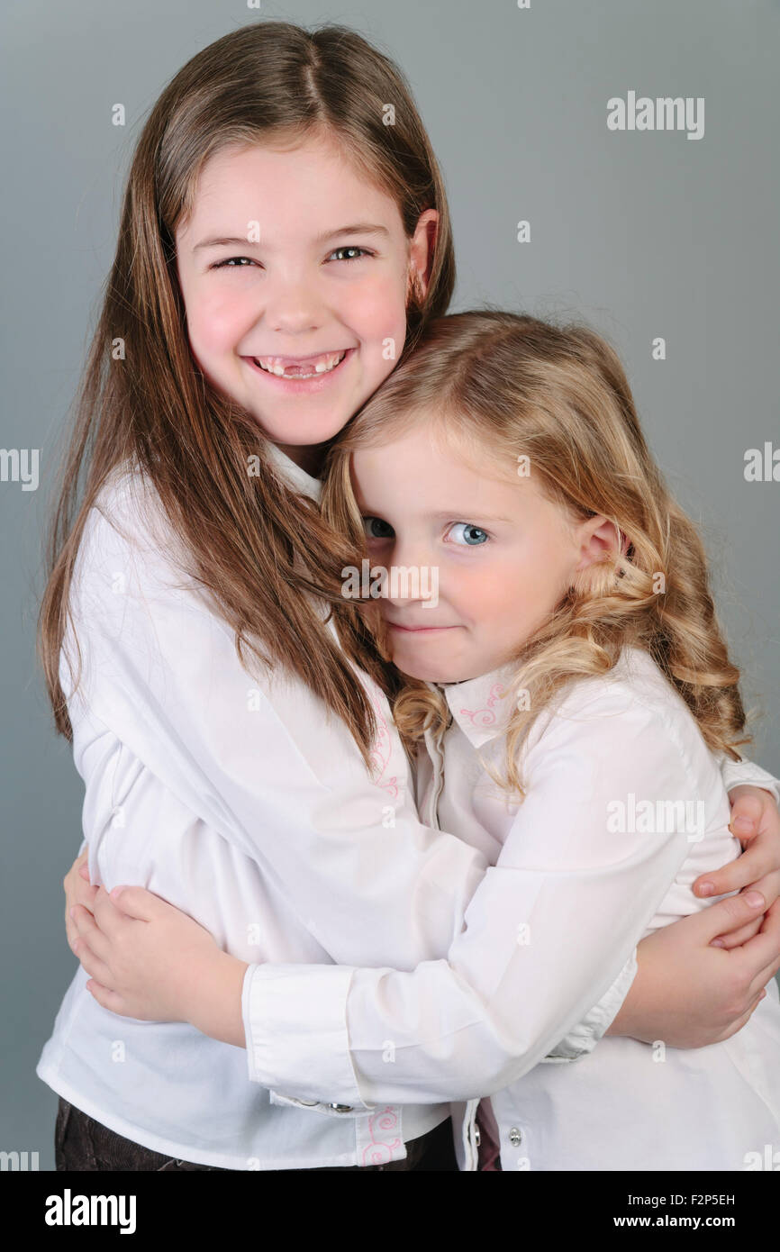 Two little sisters hugging Stock Photo - Alamy