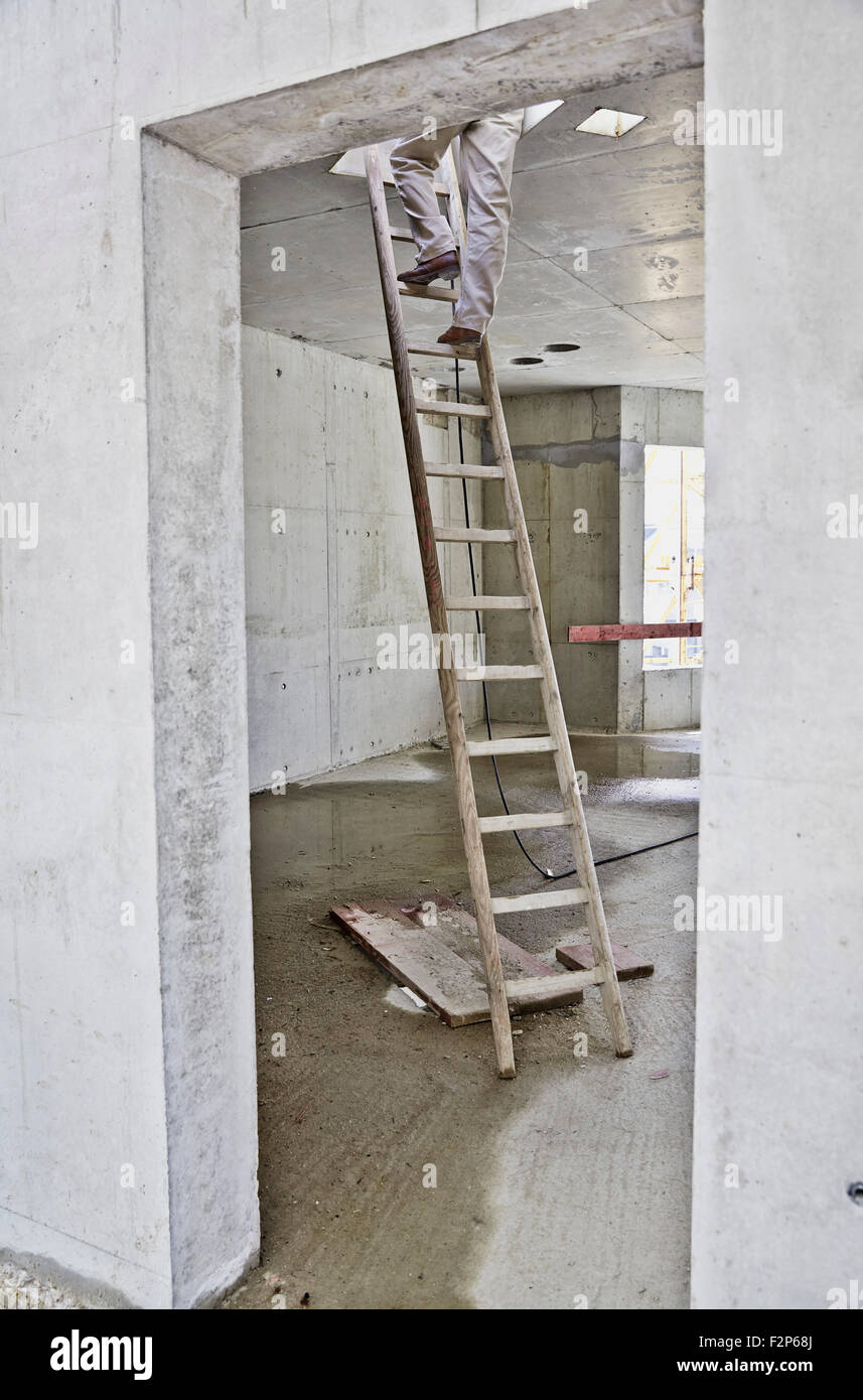 Man on ladder on construction site Stock Photo - Alamy