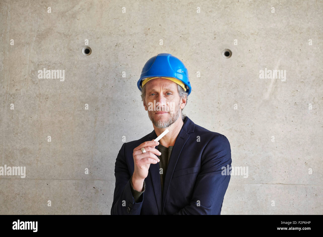 Architect on construction site thinking Stock Photo - Alamy