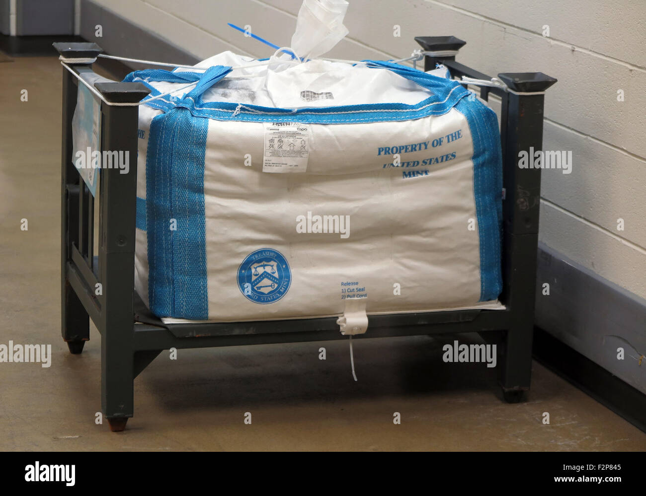A container of coins in the cash centre of the Federal Reserve Bank in ...