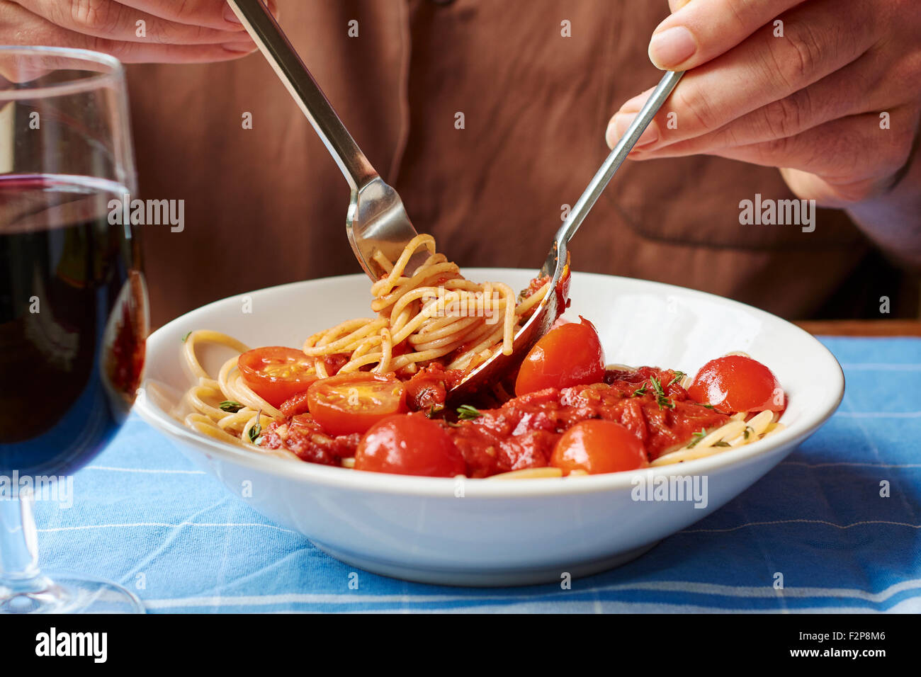 Man eating spaghetti with tomato sauce, close-up Stock Photo - Alamy