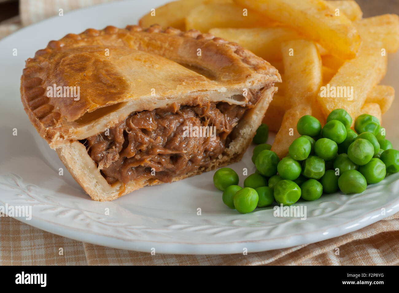 Steak or beef pie with chips or fries and green peas Stock Photo - Alamy
