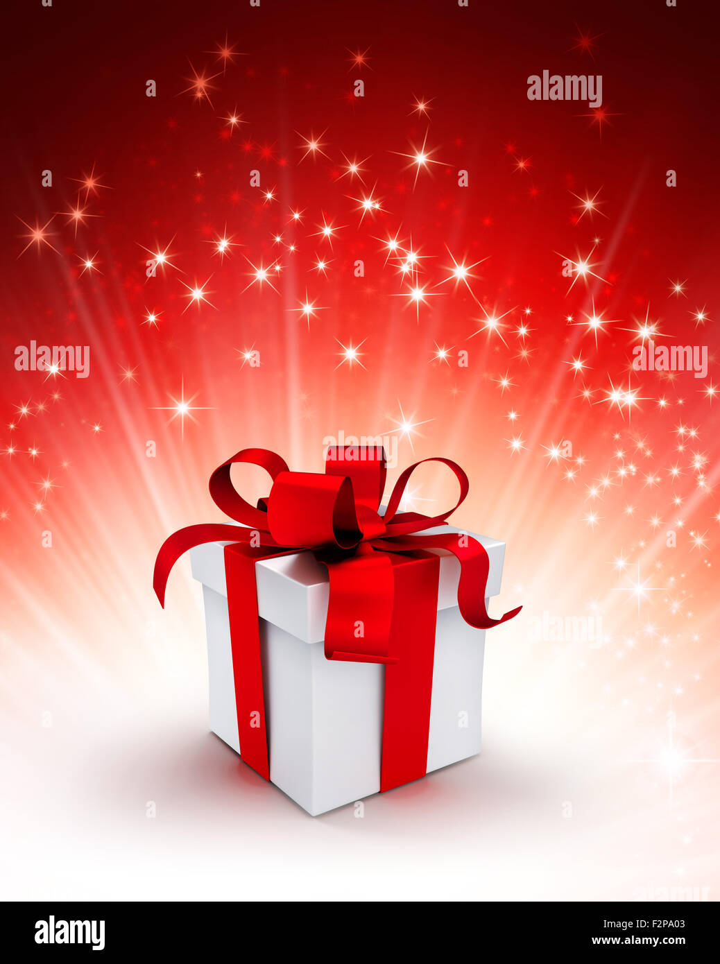 Gift box on shiny red background with starlight explosion Stock Photo ...