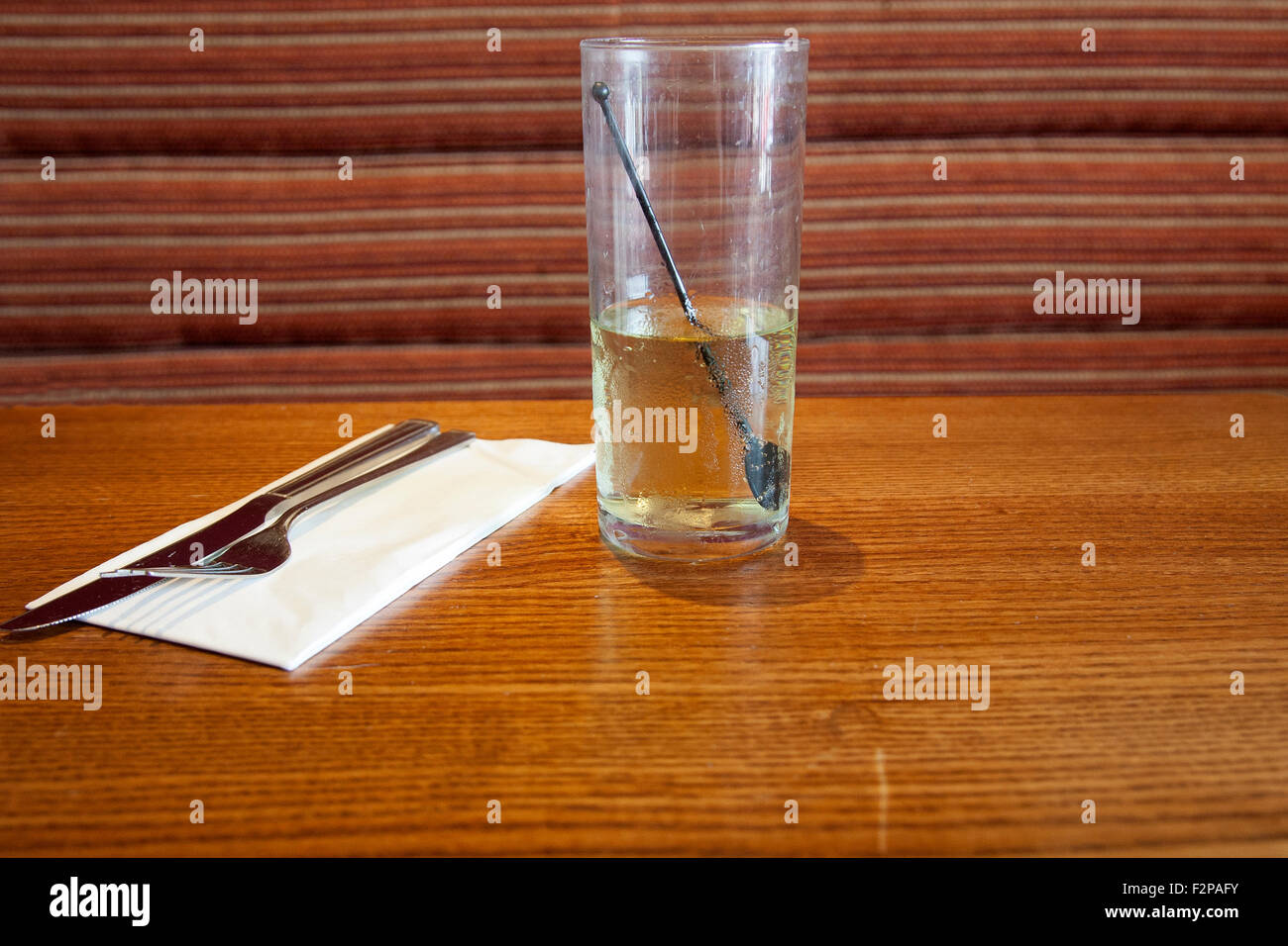 Half full glass on a table Stock Photo - Alamy