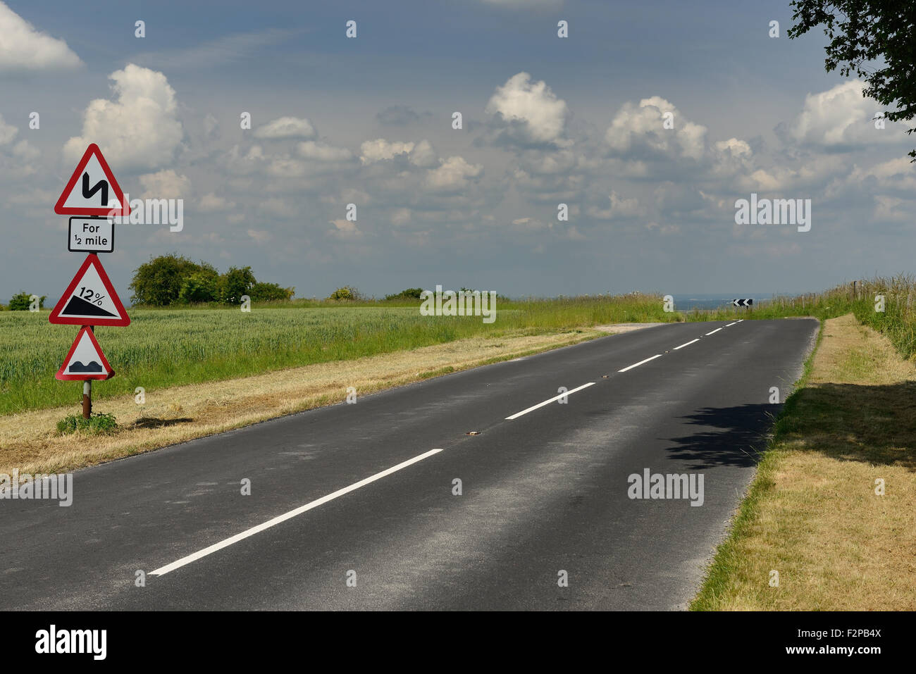 A country road approaching a sharp bend Stock Photo - Alamy