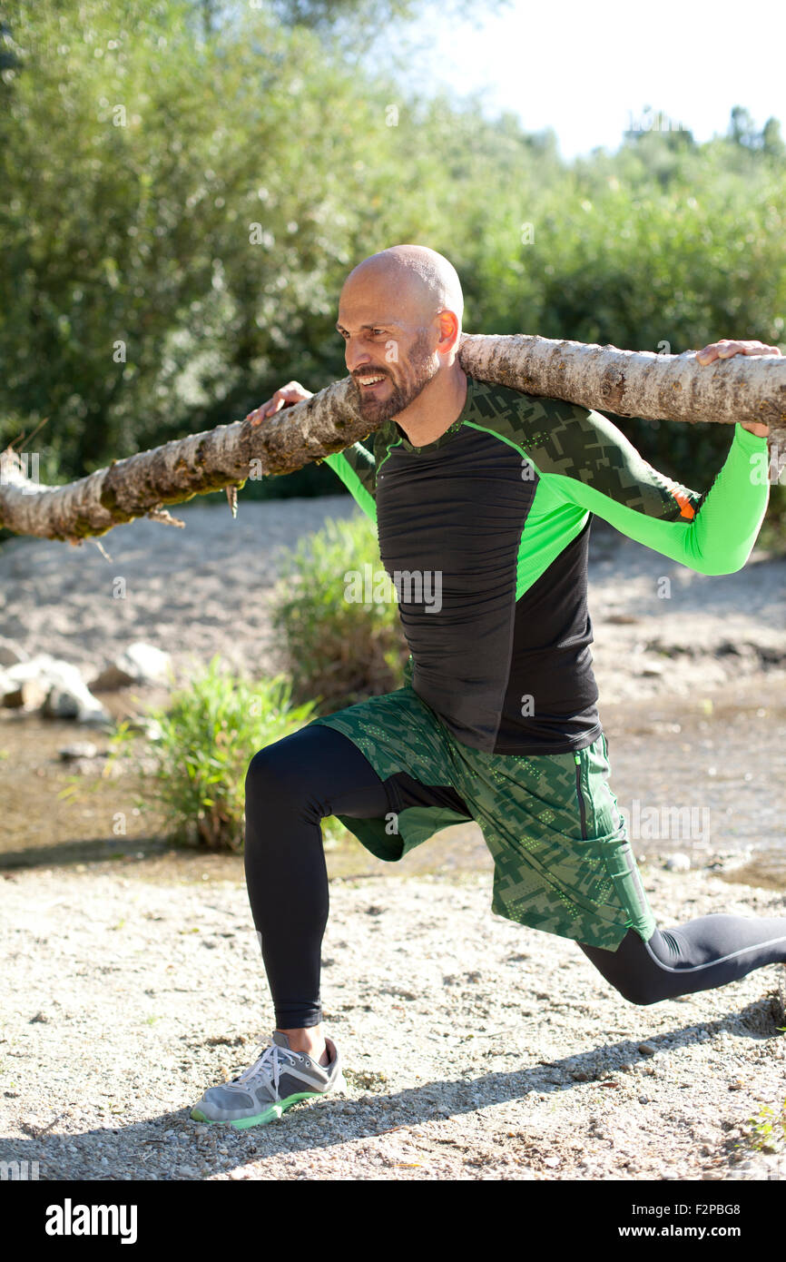 Man carrying log on shoulders hi-res stock photography and images - Alamy