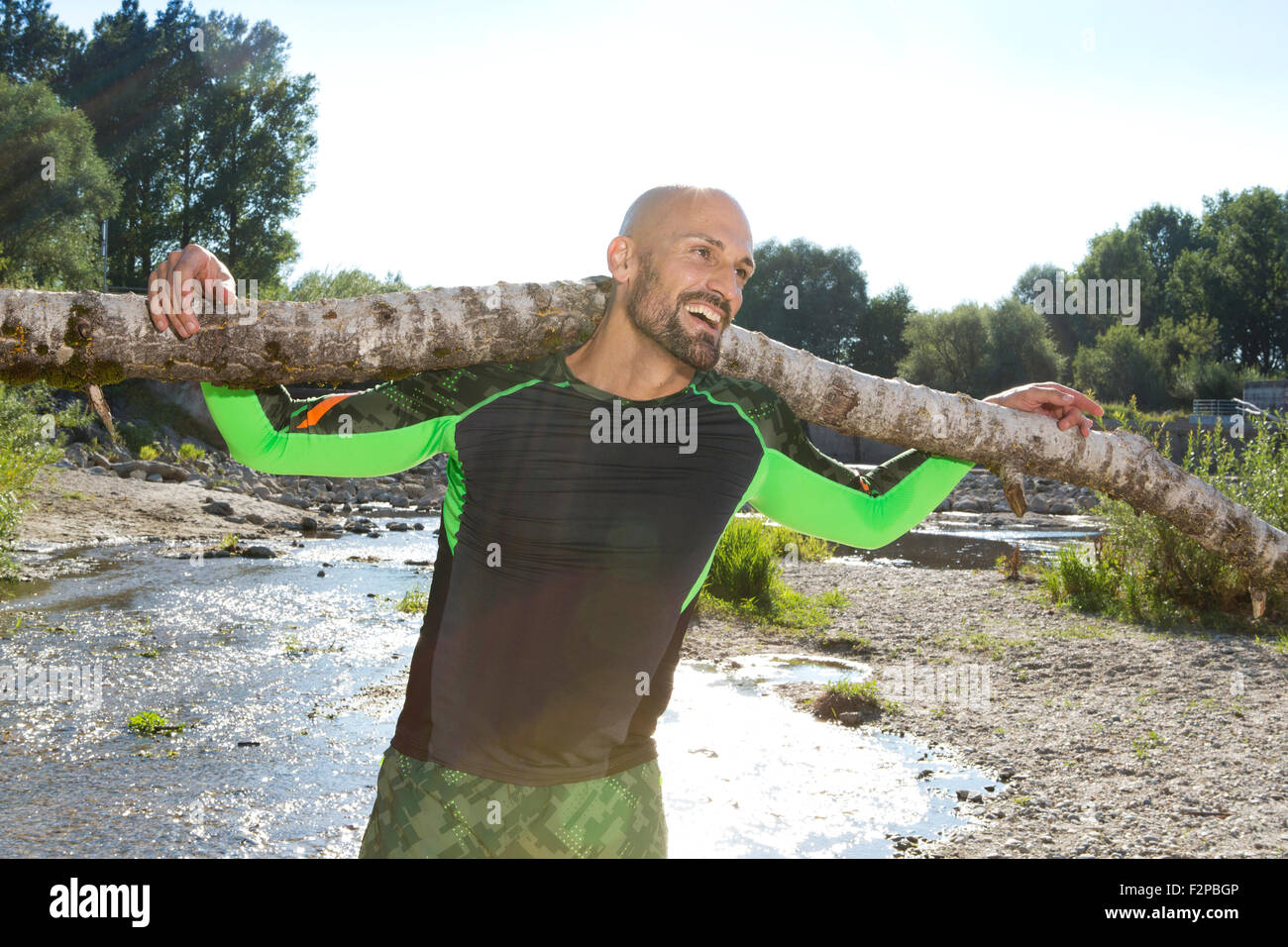 Man carrying log on shoulders hi-res stock photography and images - Alamy