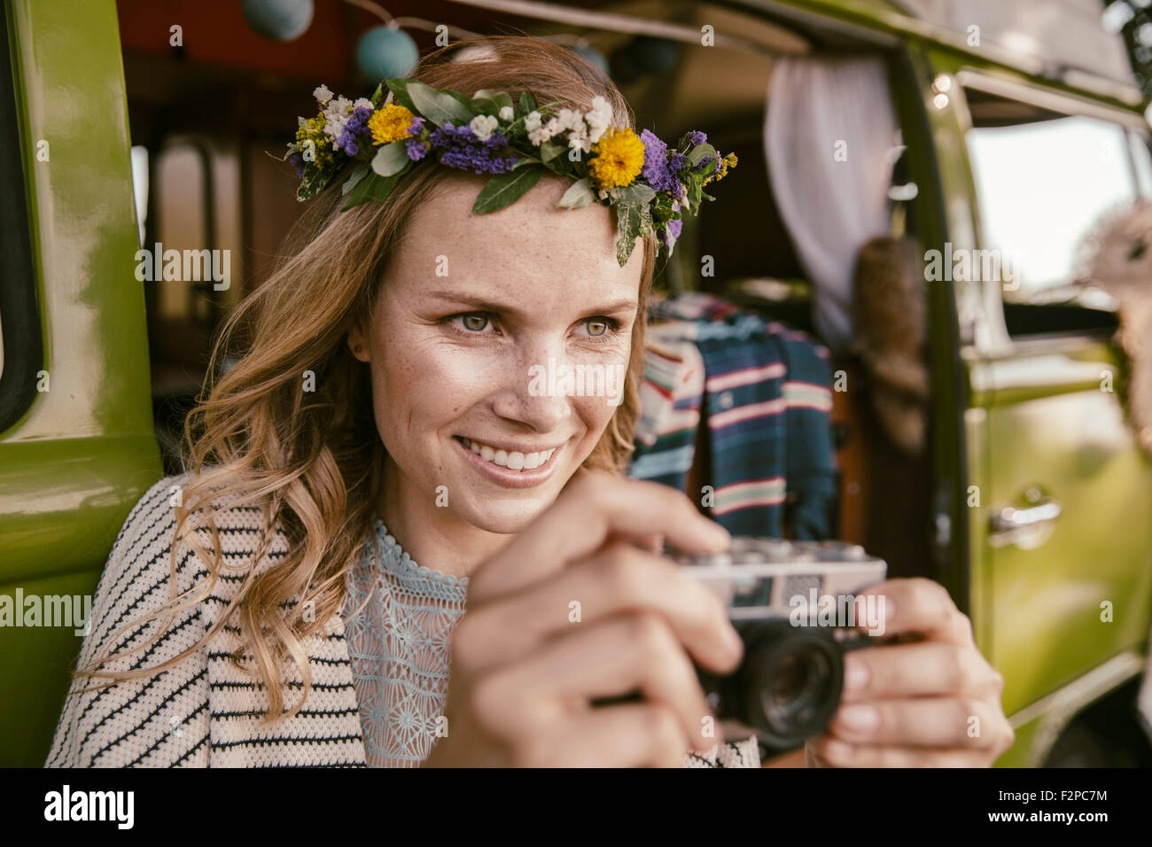 Hippie woman with analog camera in front of van Stock Photo - Alamy