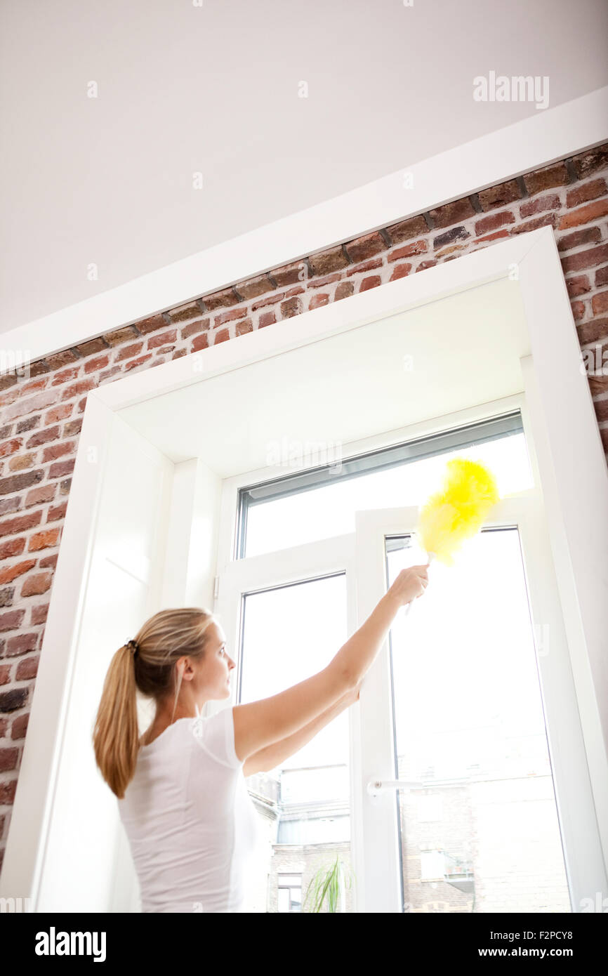 Woman dusting window Stock Photo - Alamy