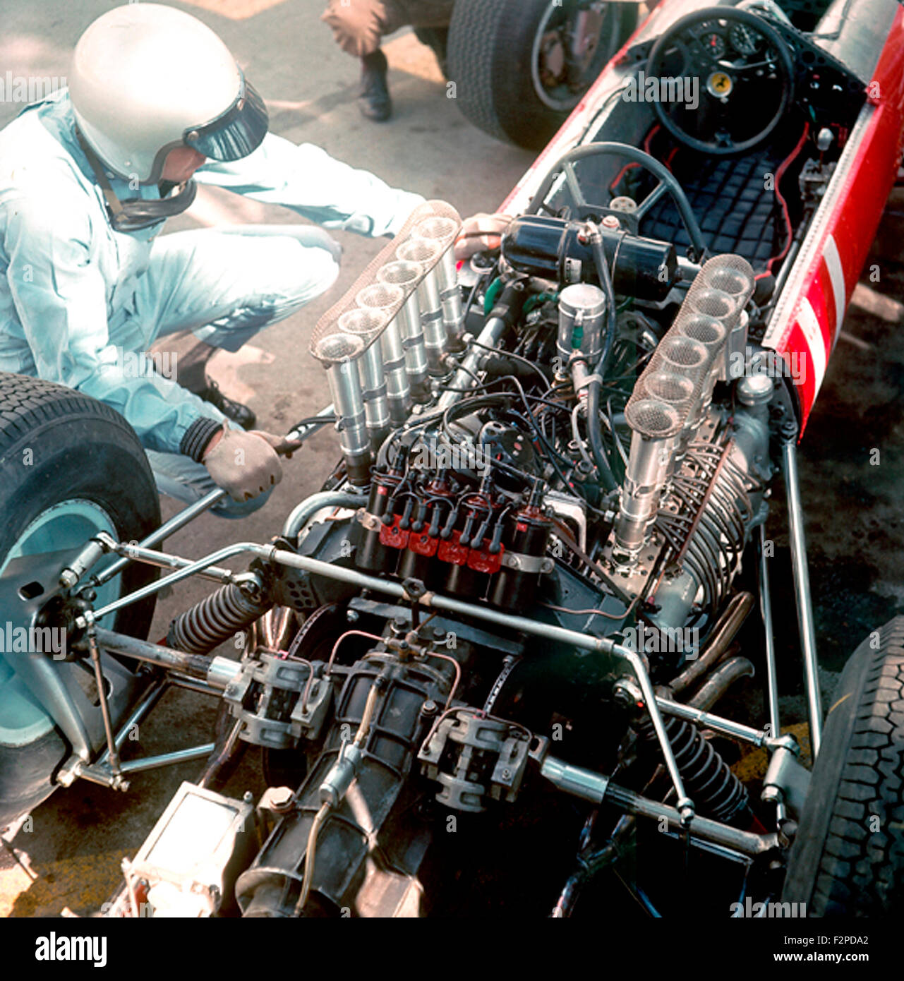 Lorenzo Bandini looking at his Ferrari 1512 at Monaco GP in Monte Carlo ...