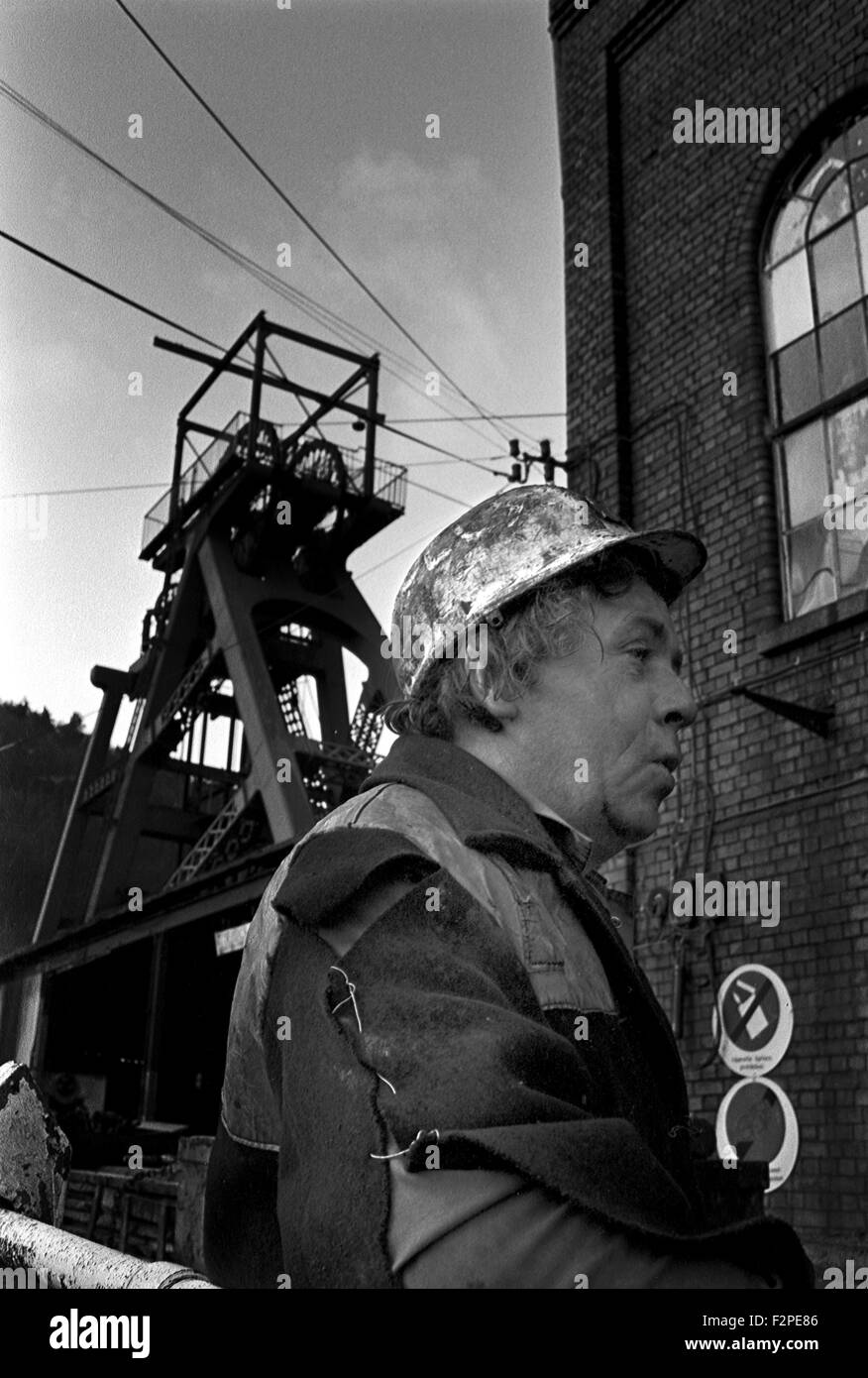 Miner talking to his butty near the pit head after a shift underground ...