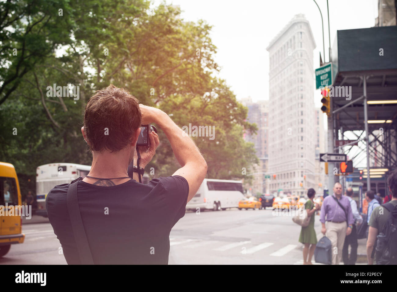 USA, New York City, Tourist taking pictures of Flatiron Building Stock ...