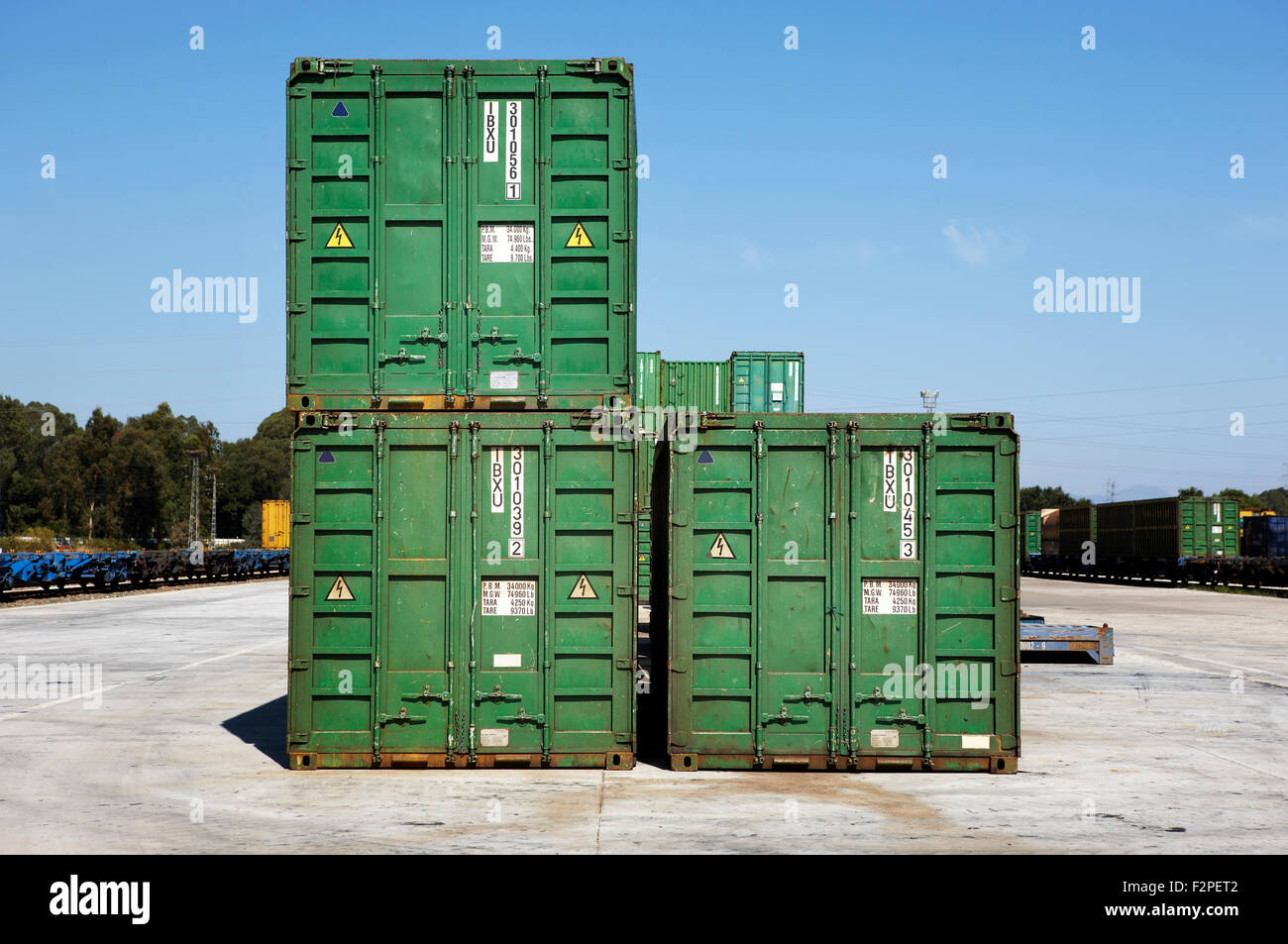 Green containers on a railway platform with freight trains Stock Photo ...