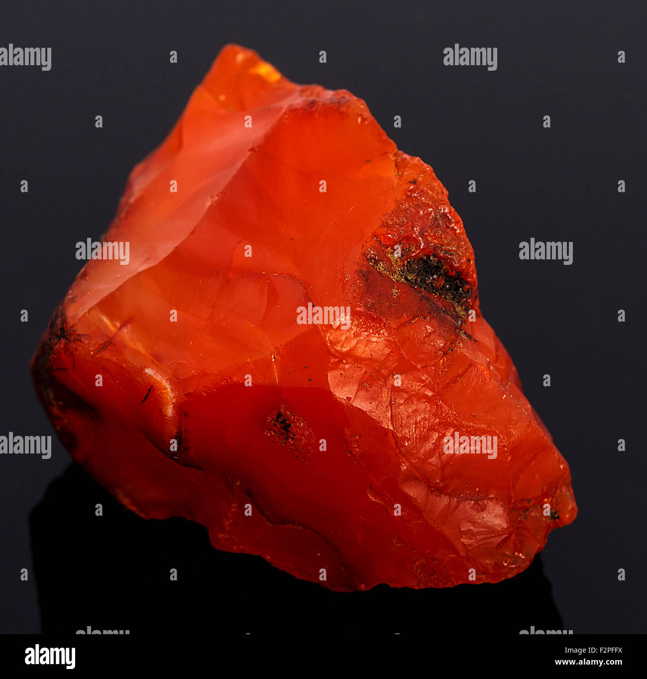 Rough red carnelian rock isolated on black background Stock Photo - Alamy