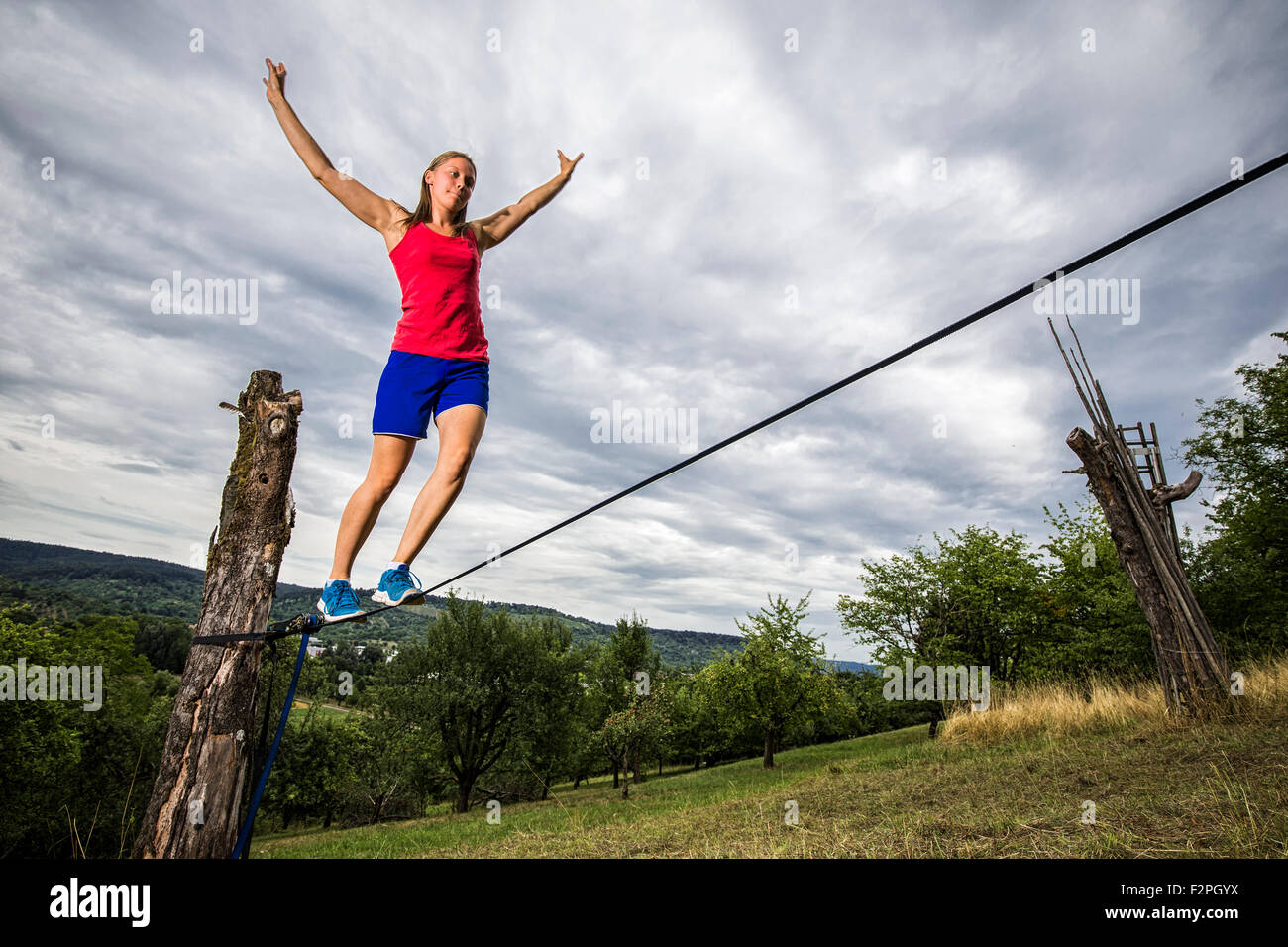 Young woman balancing on slackline Stock Photo - Alamy