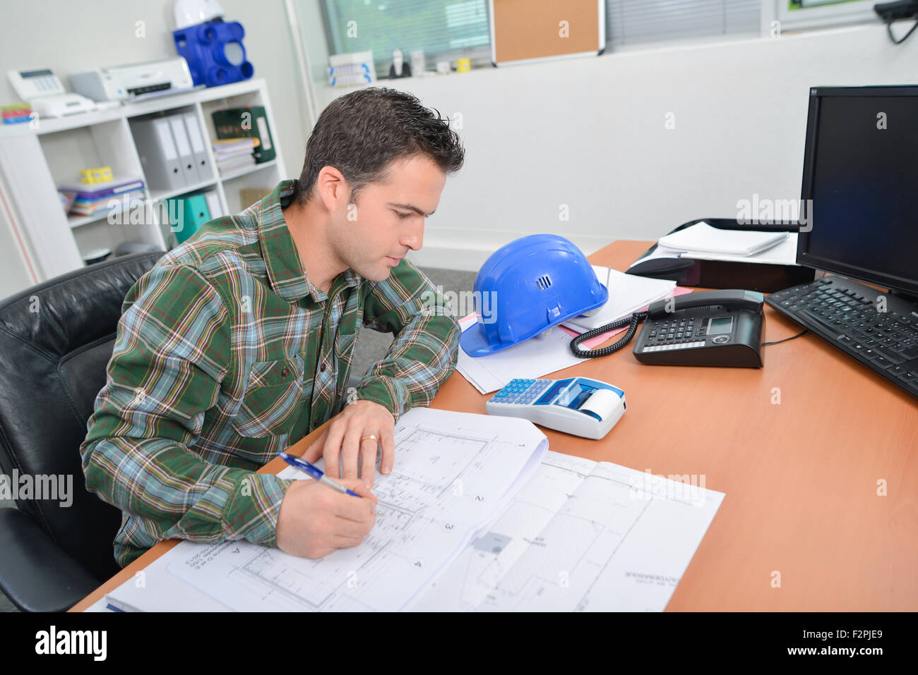 Architect making notes on house plans Stock Photo - Alamy