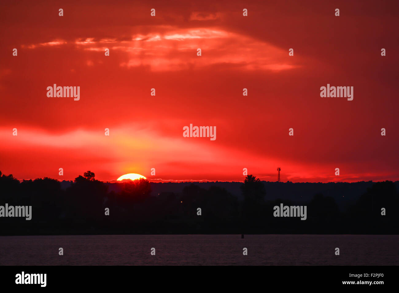 Sunset through red sky Stock Photo - Alamy