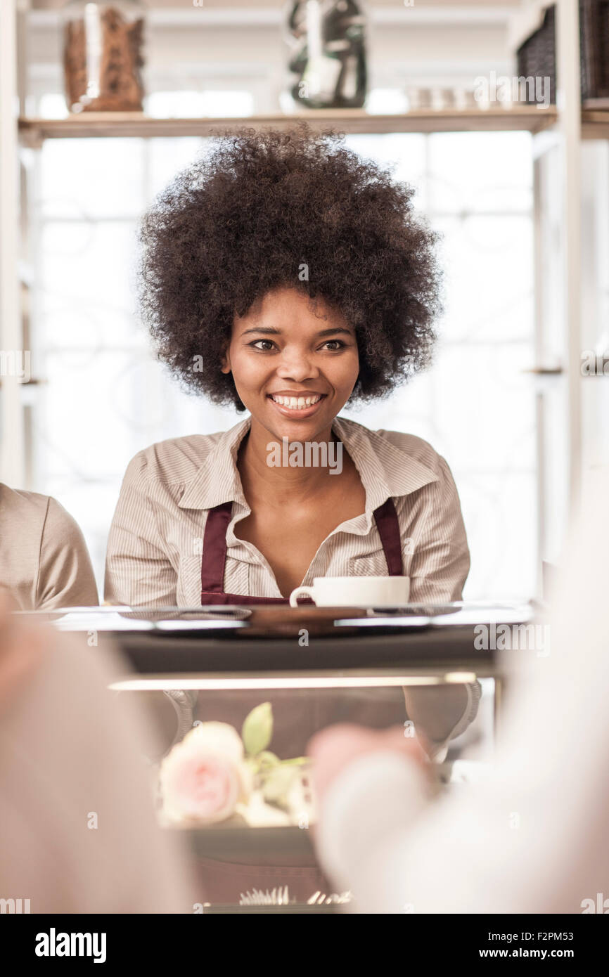 Young woman serving cake at cake counter in coffee shop Stock Photo - Alamy