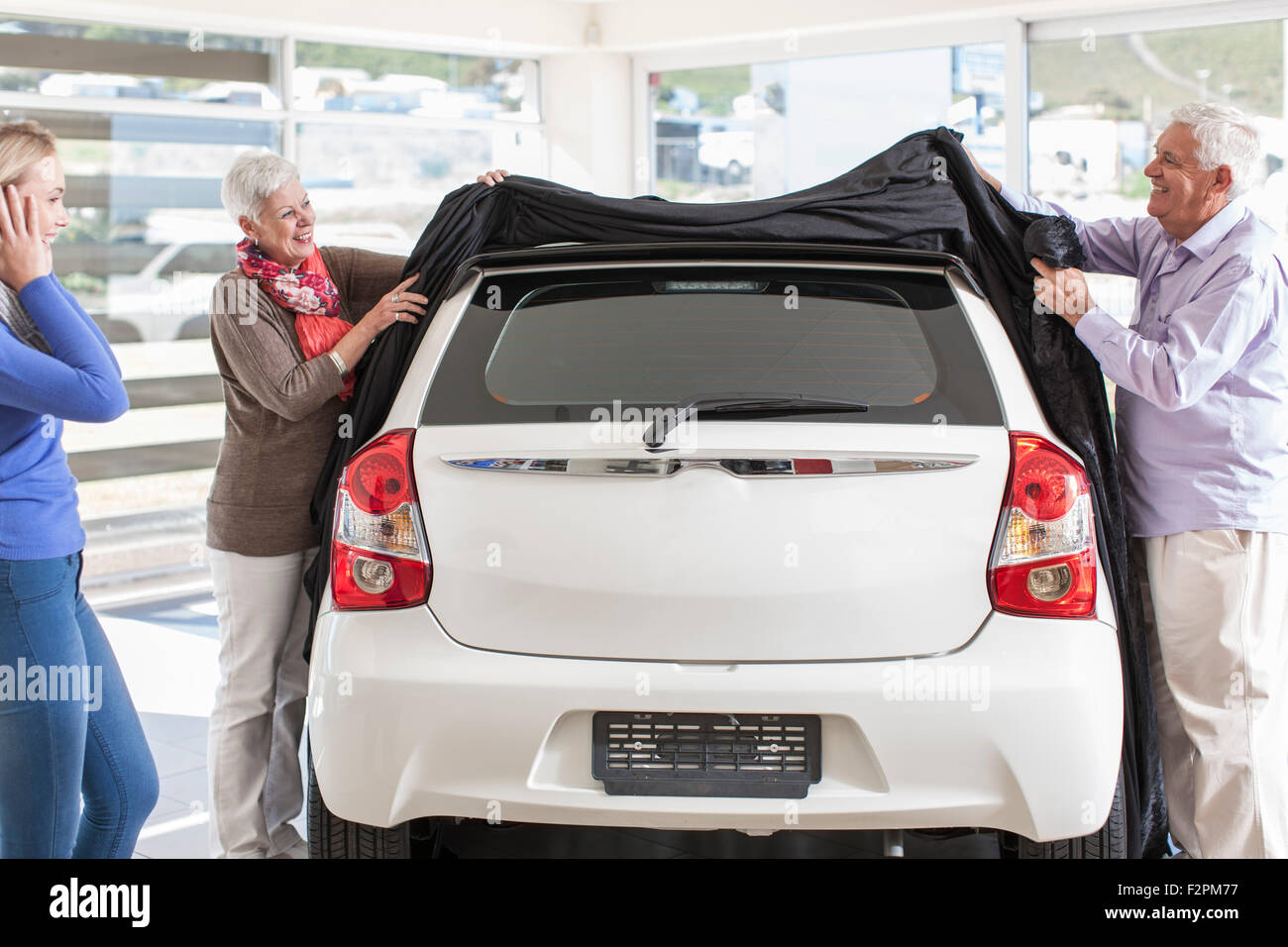 Father and mother unveiling new car as gift for the daughter Stock ...