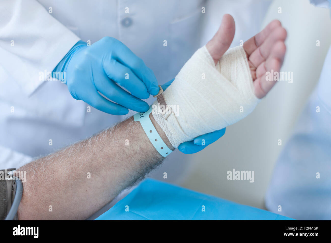 Nurse dressing a wound on patients hand Stock Photo - Alamy