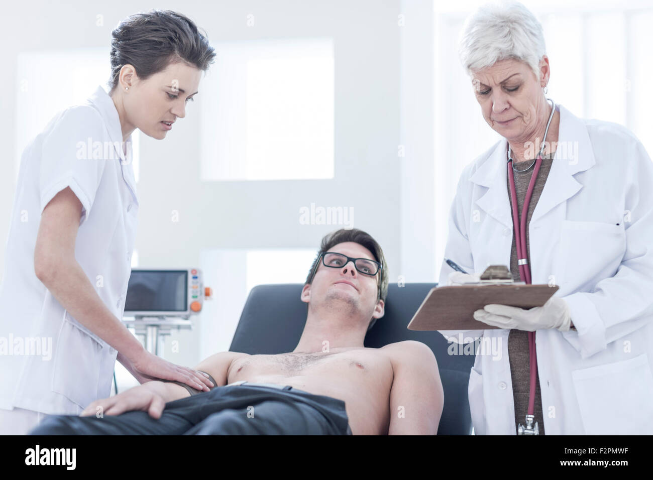 Young man in hospital getting check up Stock Photo - Alamy