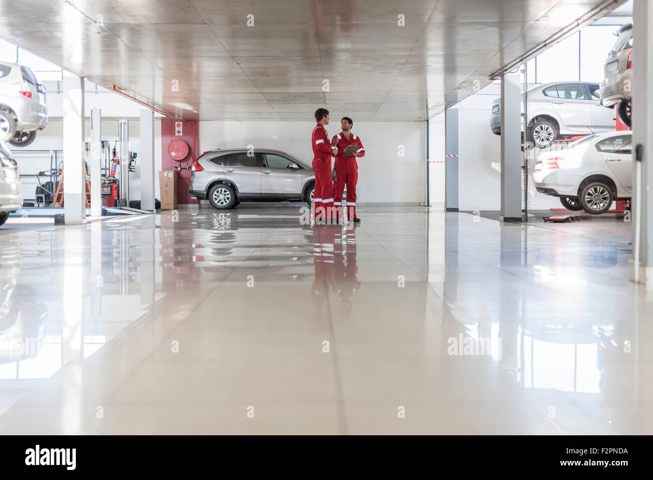 Car mechanics in repair garage Stock Photo - Alamy