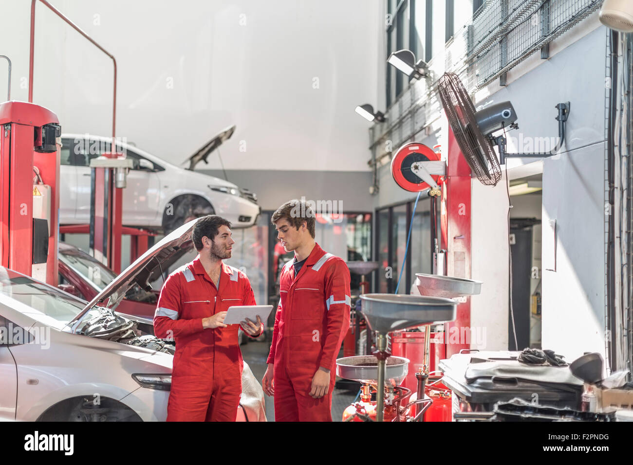 Car mechanics at work in repair garage Stock Photo - Alamy