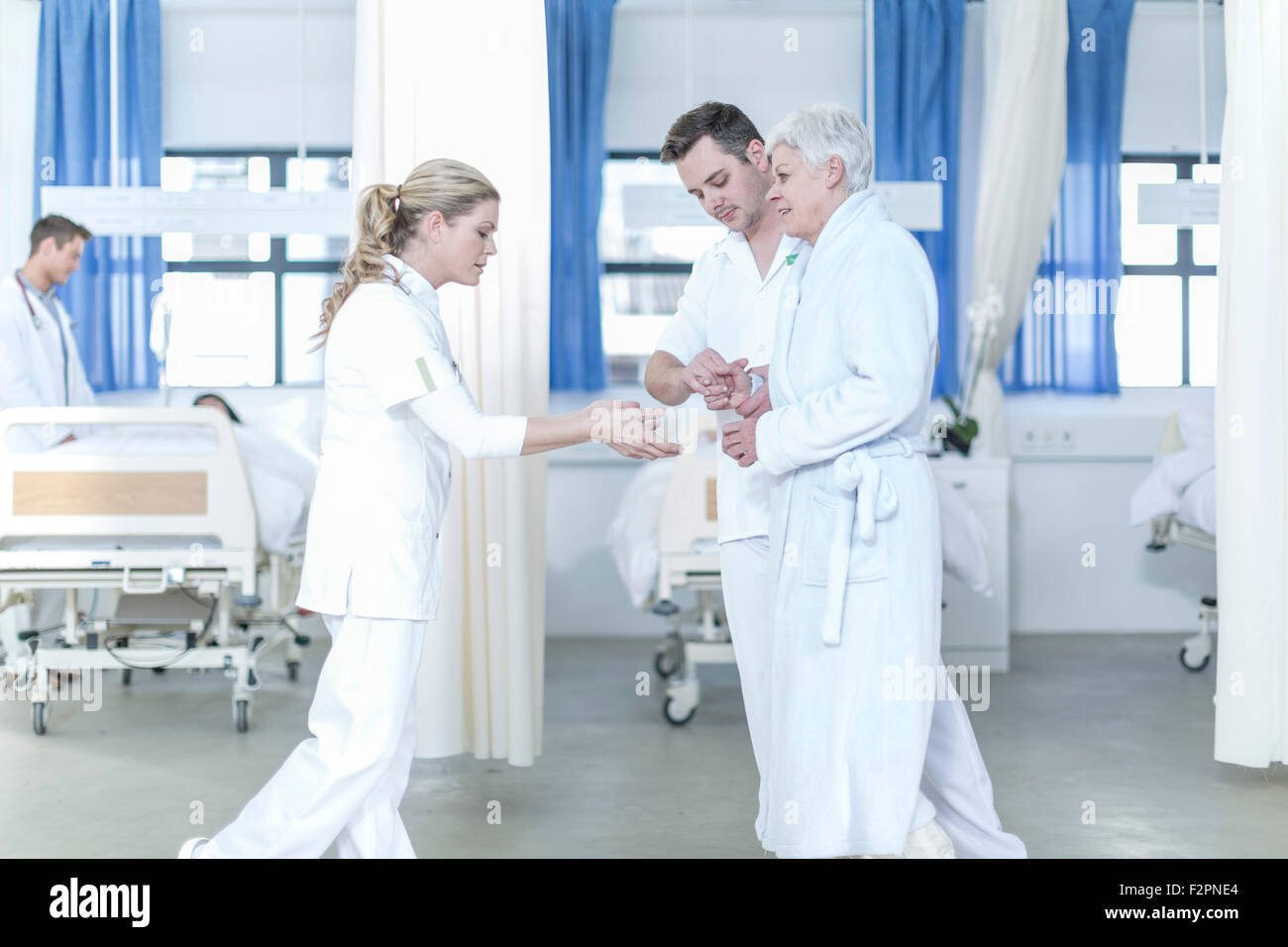 Hospital staff supporting senior patient Stock Photo - Alamy