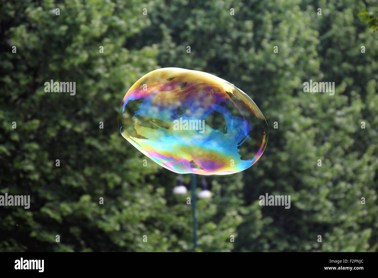 Giant soap bubbles created with ropes and sticks in a park Stock Photo ...